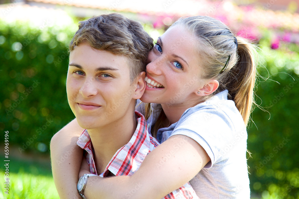 Blonde girl in love with boyfriend biting his ear Stock Photo | Adobe Stock