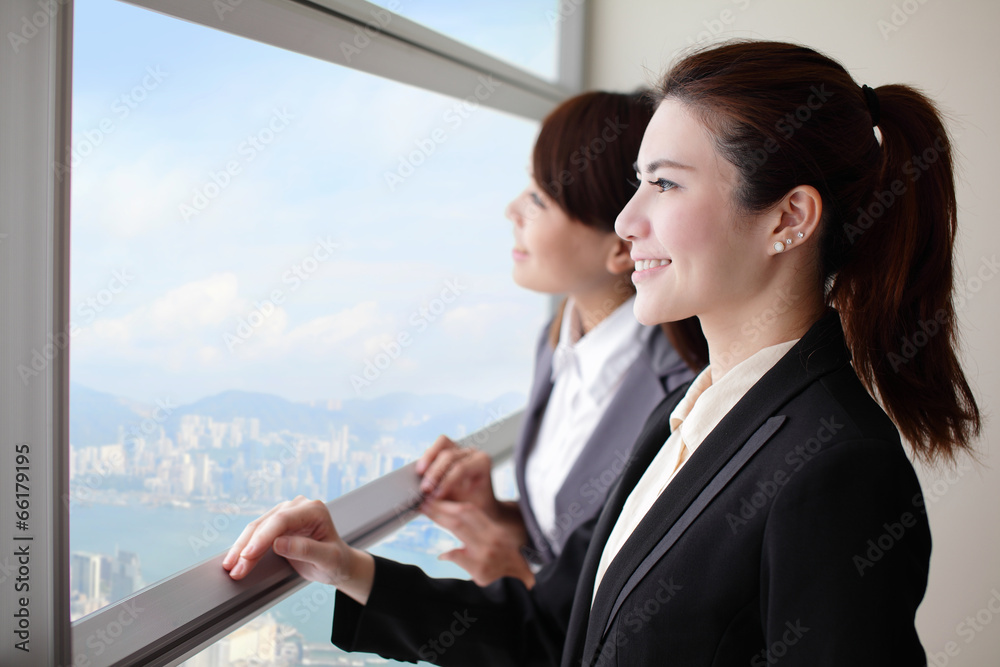 Business woman looking through window Stock Photo | Adobe Stock