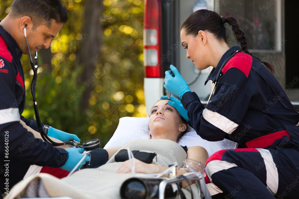 emergency medical technicians checking patients vital signs Stock Photo ...