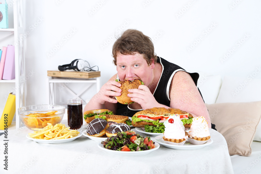 Fat man eating a lot of unhealthy food, Stock Photo | Adobe Stock