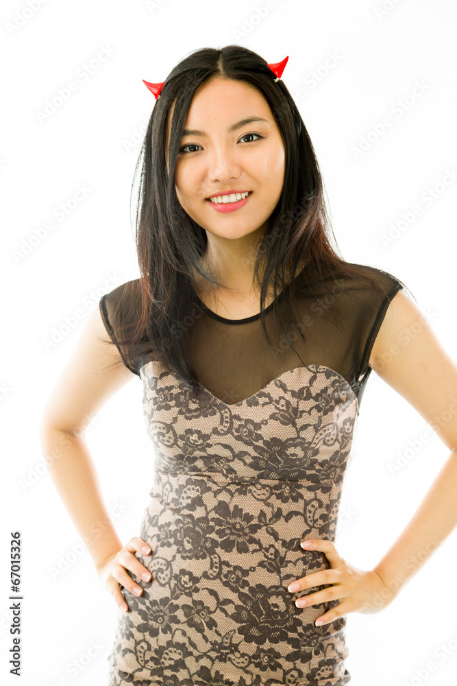 Asian young woman dressed up as a devil and standing with her Stock ...
