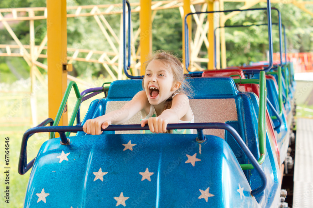 Funny girl screaming in the roller coaster Stock Photo | Adobe Stock