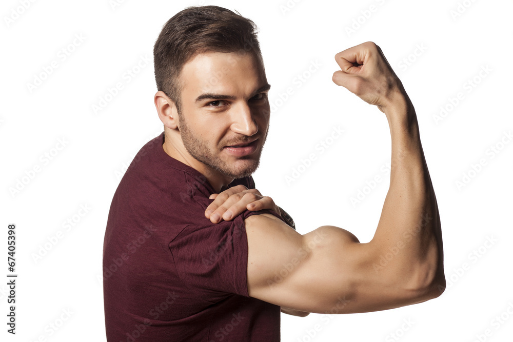 young handsome guy shows his strong arm foto de Stock | Adobe Stock