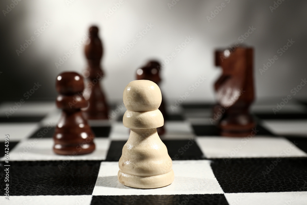 Chess board with chess pieces on grey background Stock Photo | Adobe Stock