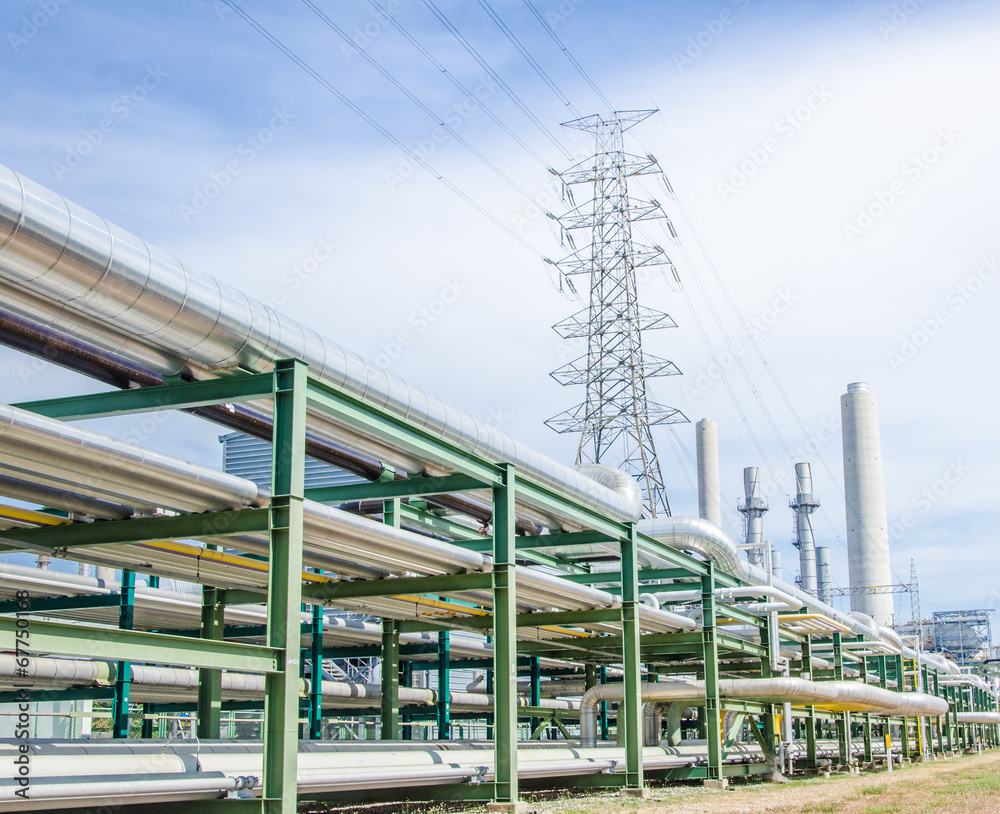 High-voltage transmission tower with pipe rack in industrial est Stock ...