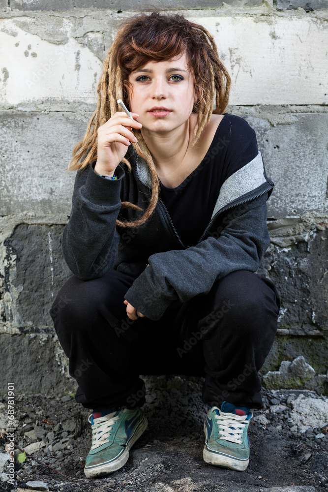 Foto de Young rastafarian girl smoking weed do Stock | Adobe Stock