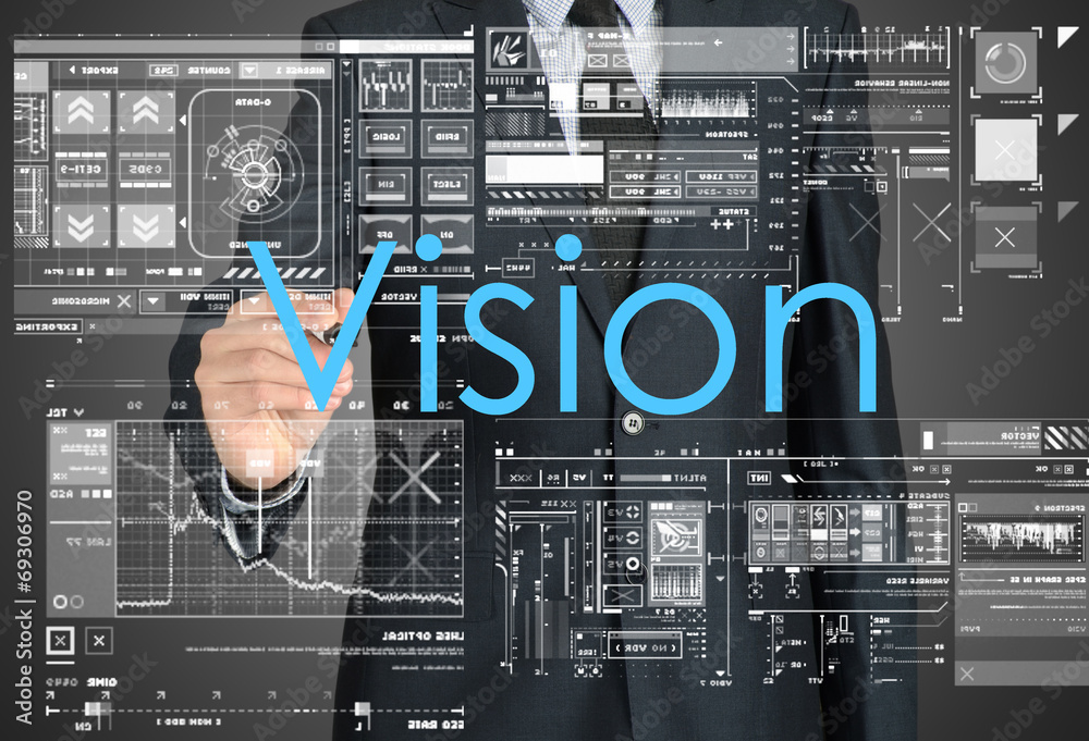 the businessman is writing Vision on the transparent board with some ...