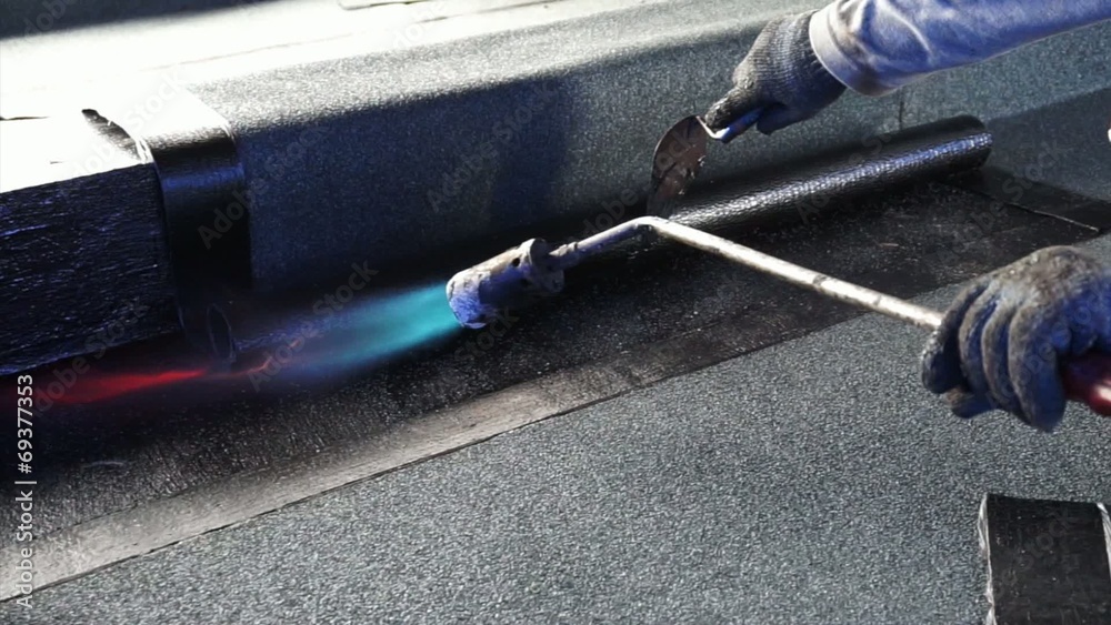 Video Stock bitumen roofing, asphalt installation with fire | Adobe Stock