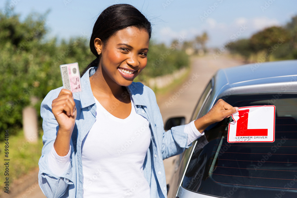 african woman removing learner driver sign Stock Photo | Adobe Stock