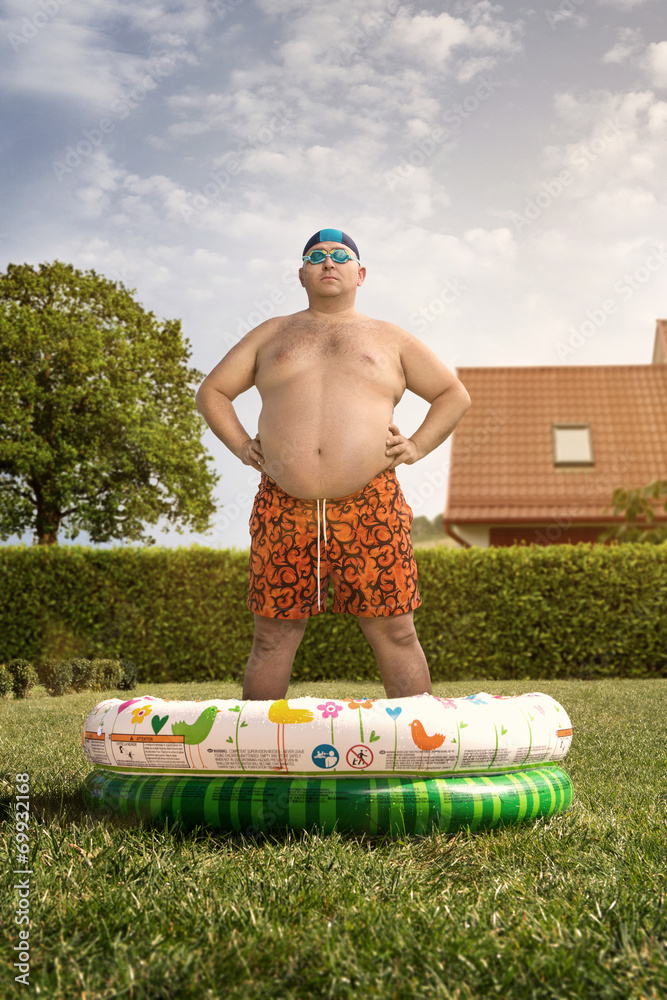 Funny overweight man about to swim in the back yard pool Stock Photo ...