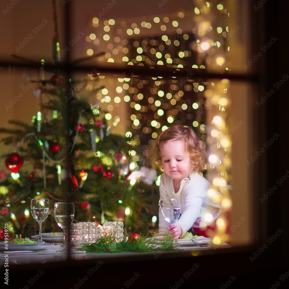Little girl at Christmas dinner Stock Photo | Adobe Stock