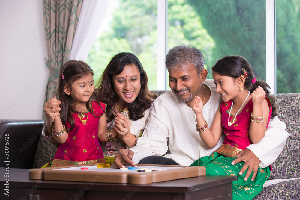 Indian family playing carrom game at home. Parents and children Stock ...