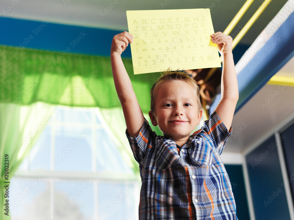 proud little boy showing his completed alphabet worksheet Stock Photo ...