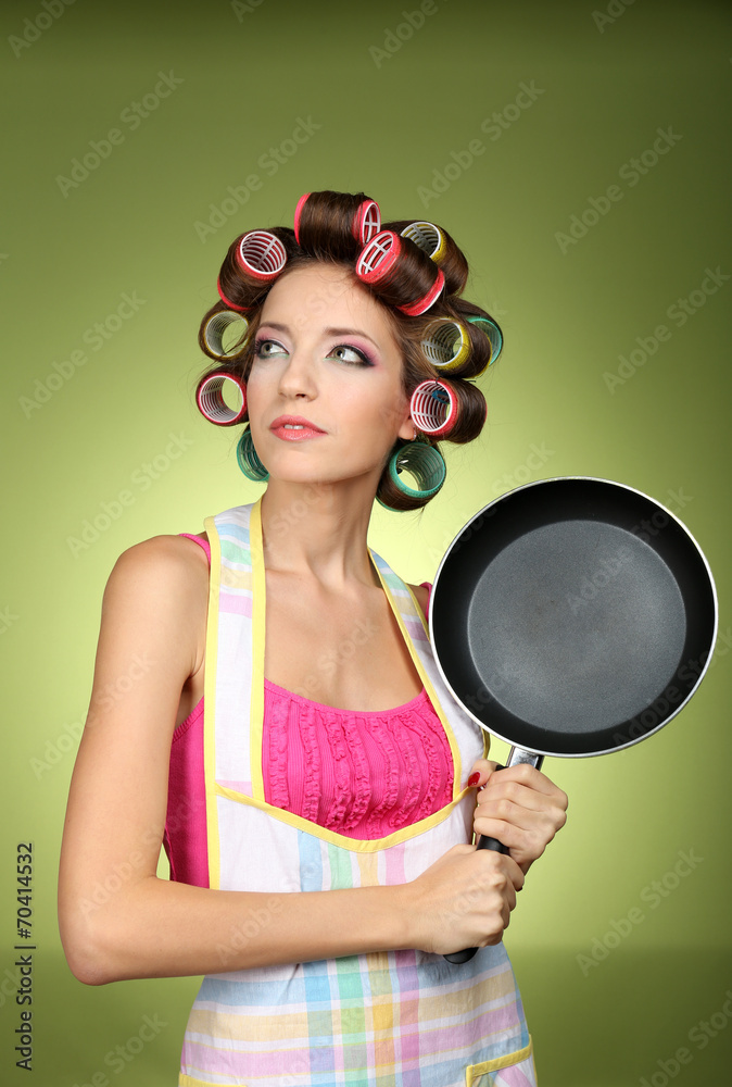 Beautiful girl in hair curlers on green background Stock Photo | Adobe ...