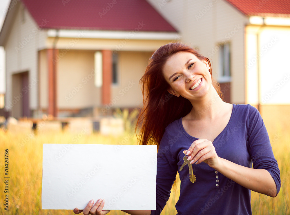beautiful girl in front of house with a sign and keys Stock Photo ...