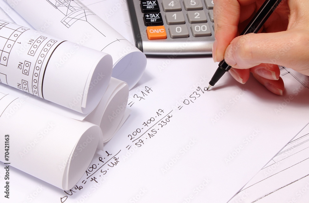 Rolled diagrams, calculator and mathematical calculations Stock Photo ...
