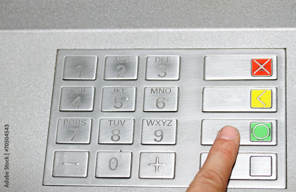 hand typing the secret code in the keyboard of an ATM Stock Photo ...