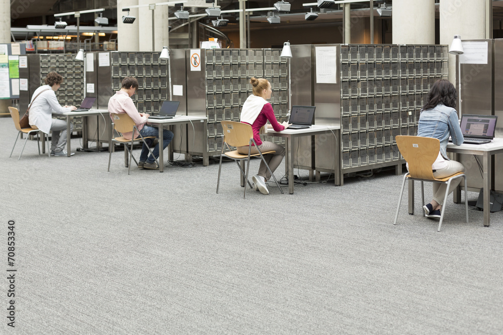 Students in a university library using laptops Stock Photo | Adobe Stock