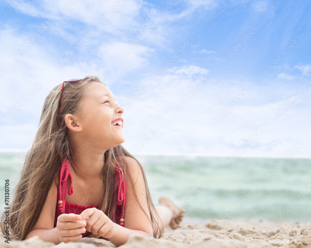 beautiful little girl lying on the sandy sea beach Stock Photo | Adobe ...