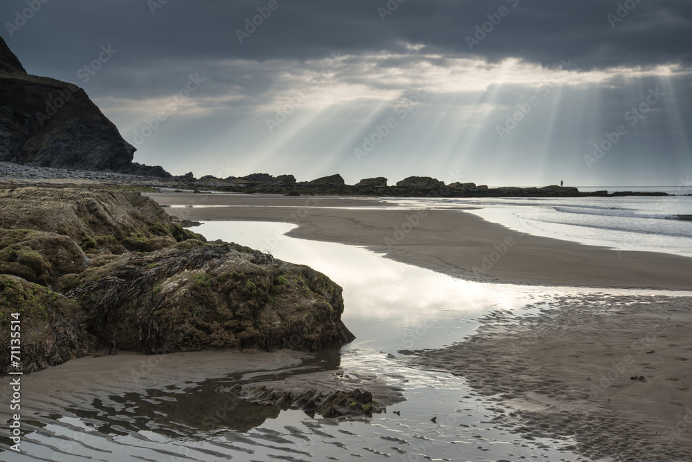 Stunning sun rays bursting from sky over empty yellow sand beach Stock ...