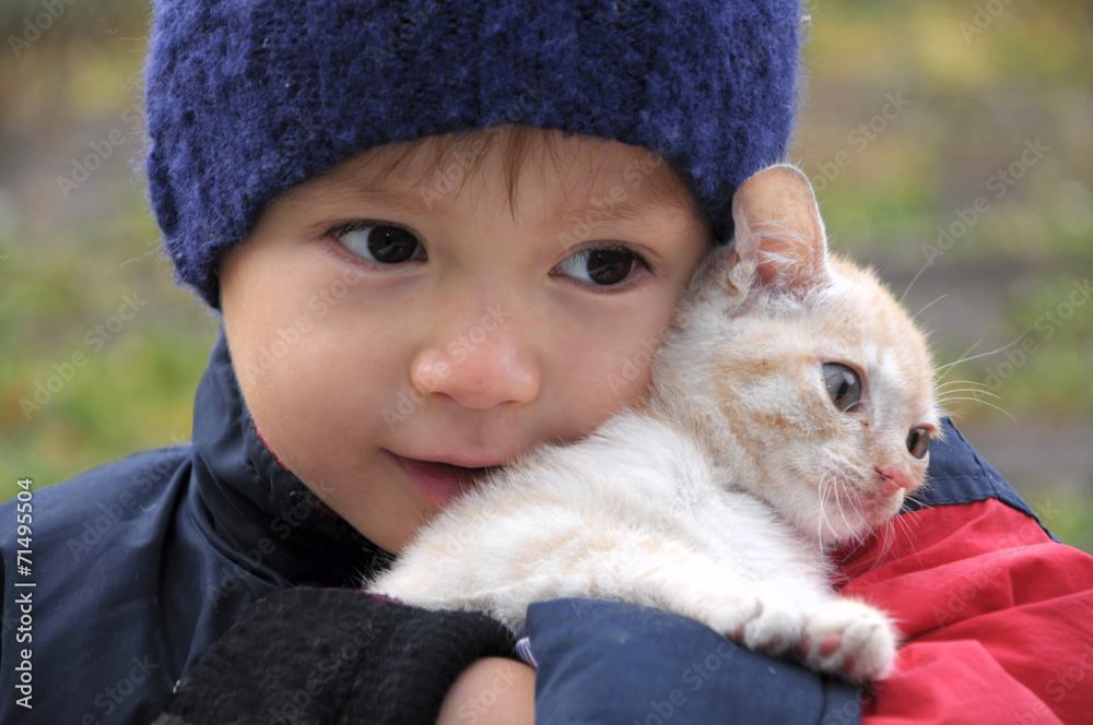 Boy smiling hugging cat Stock Photo | Adobe Stock