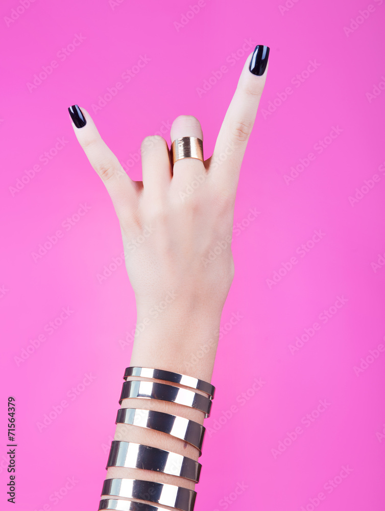 Woman hand giving the devil horns gesture Stock Photo | Adobe Stock