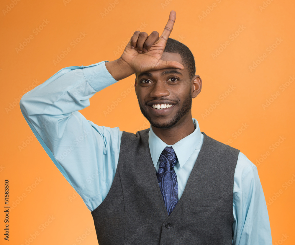 man showing loser sign on forehead isolated on orange background Stock ...