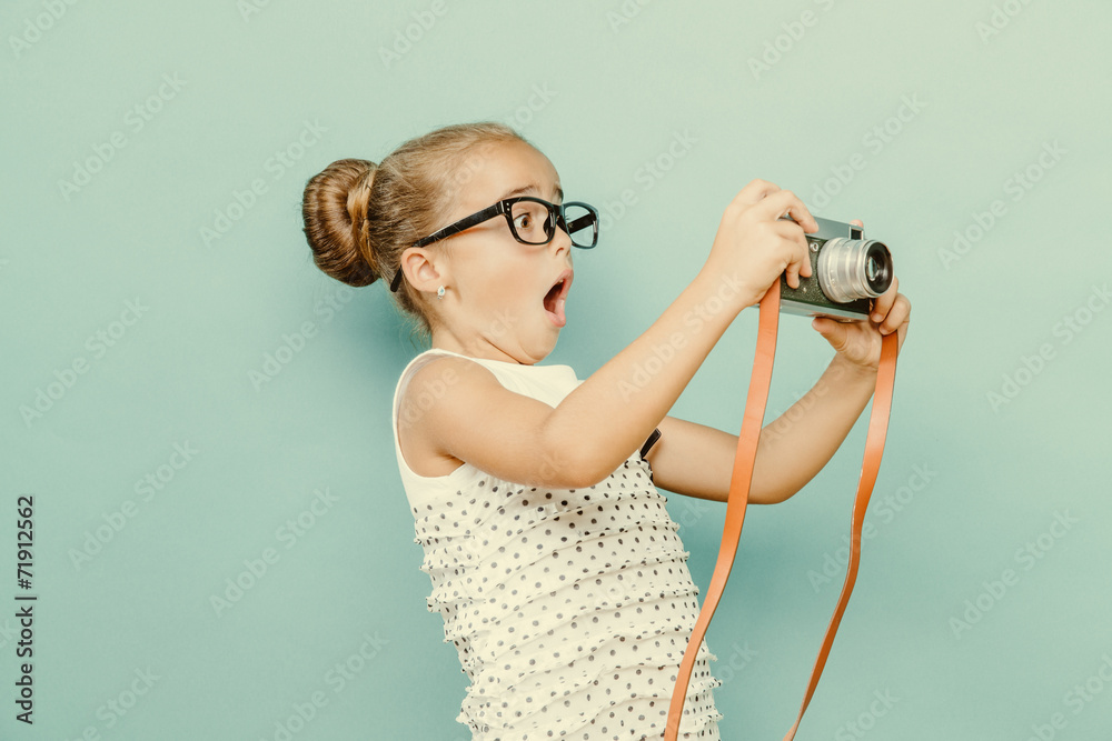 child holding a instant camera Stock-Foto | Adobe Stock