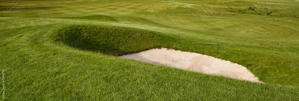 Deep golf bunker on a summer golf course Photos | Adobe Stock