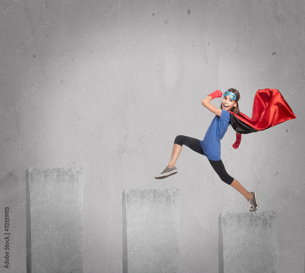 little girl wearing a superhero costume on a growing chart foto de ...