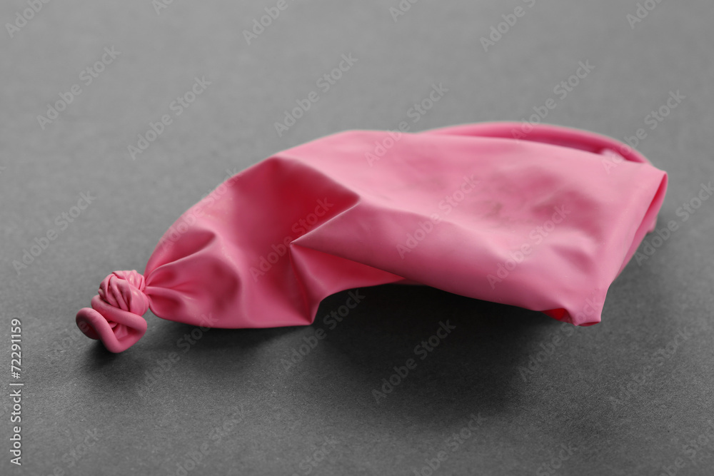 Popped pink balloon on paper background Stock Photo | Adobe Stock