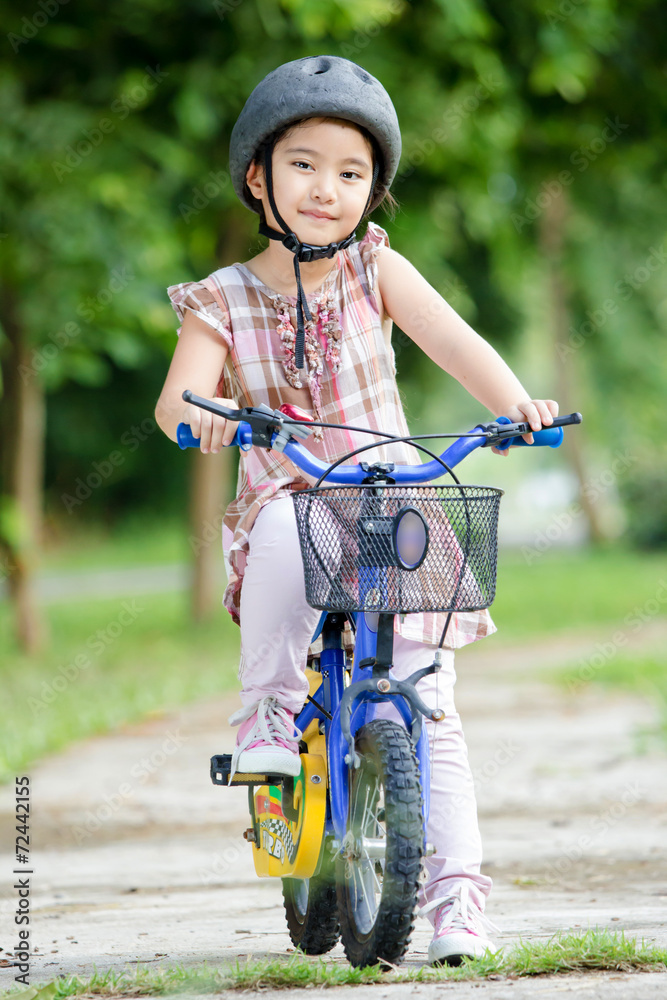 Little Asian child riding a bicycle Stock Photo | Adobe Stock