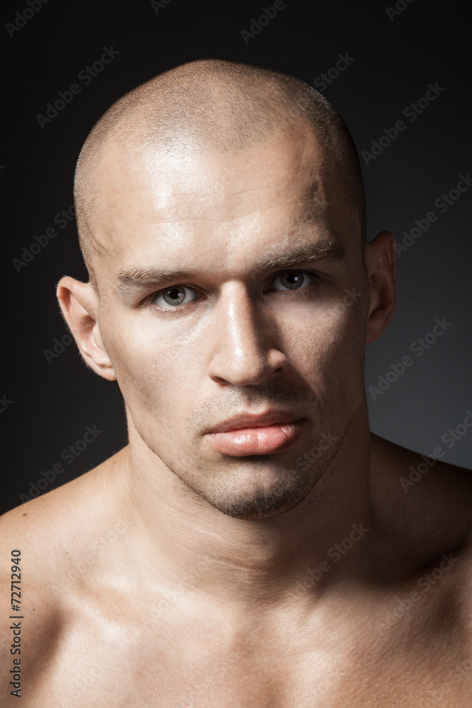 strong man portrait isolated on dark background Stock Photo | Adobe Stock