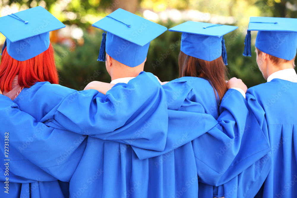 Graduate students wearing graduation hat and gown, outdoors Stock Photo ...