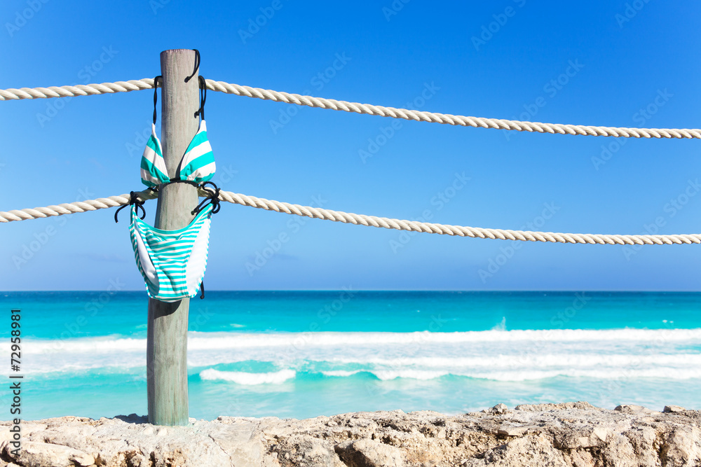 Swimming stripped bikini hang on ropes of pier Stock Photo | Adobe Stock