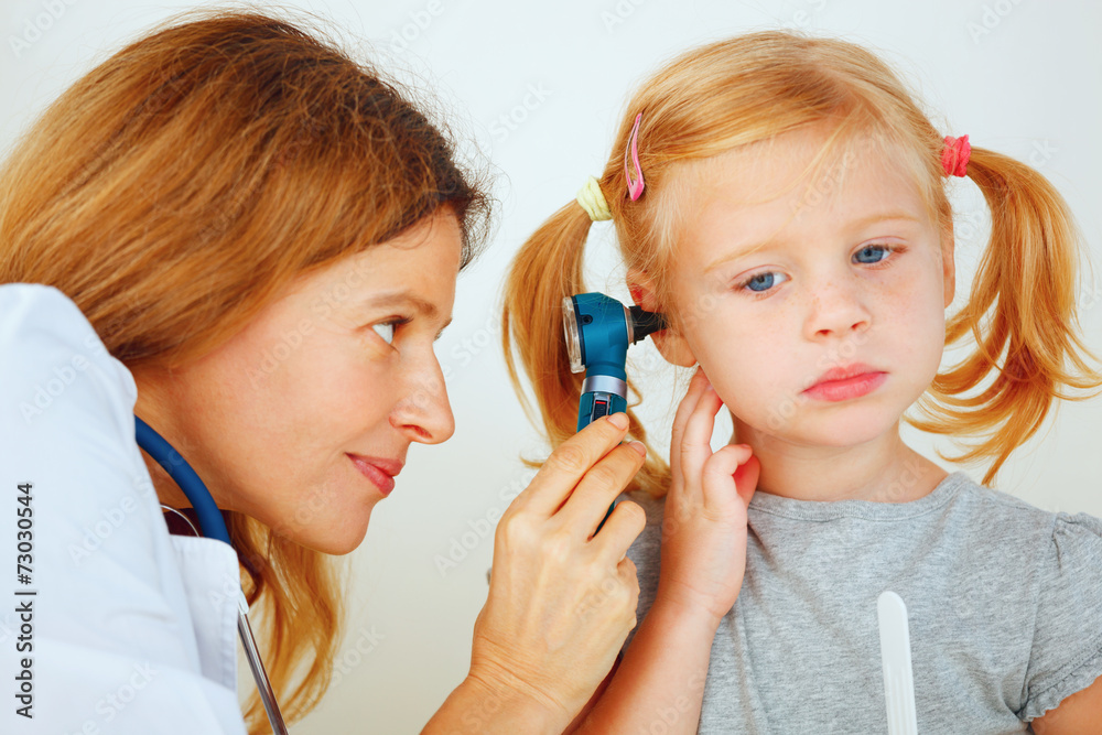 Pediatrician doctor examining little girl ears. Stock Photo | Adobe Stock
