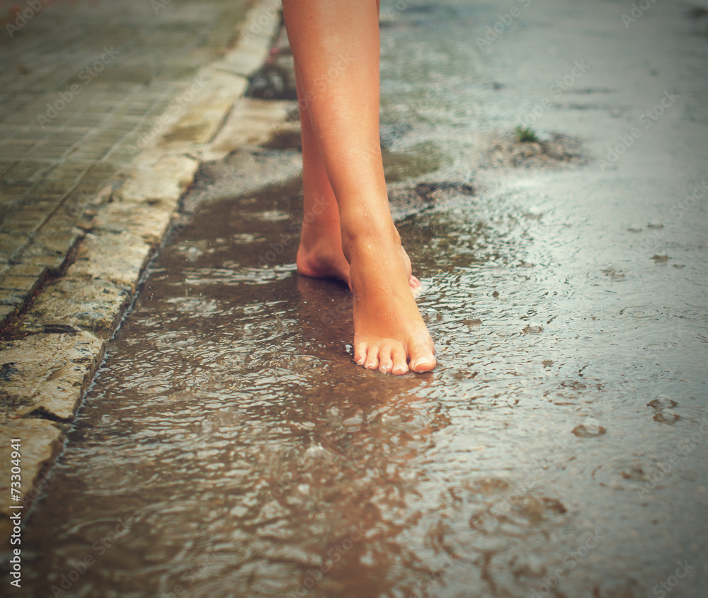 Woman enjoying tropical rain. Legs. Stock Photo | Adobe Stock