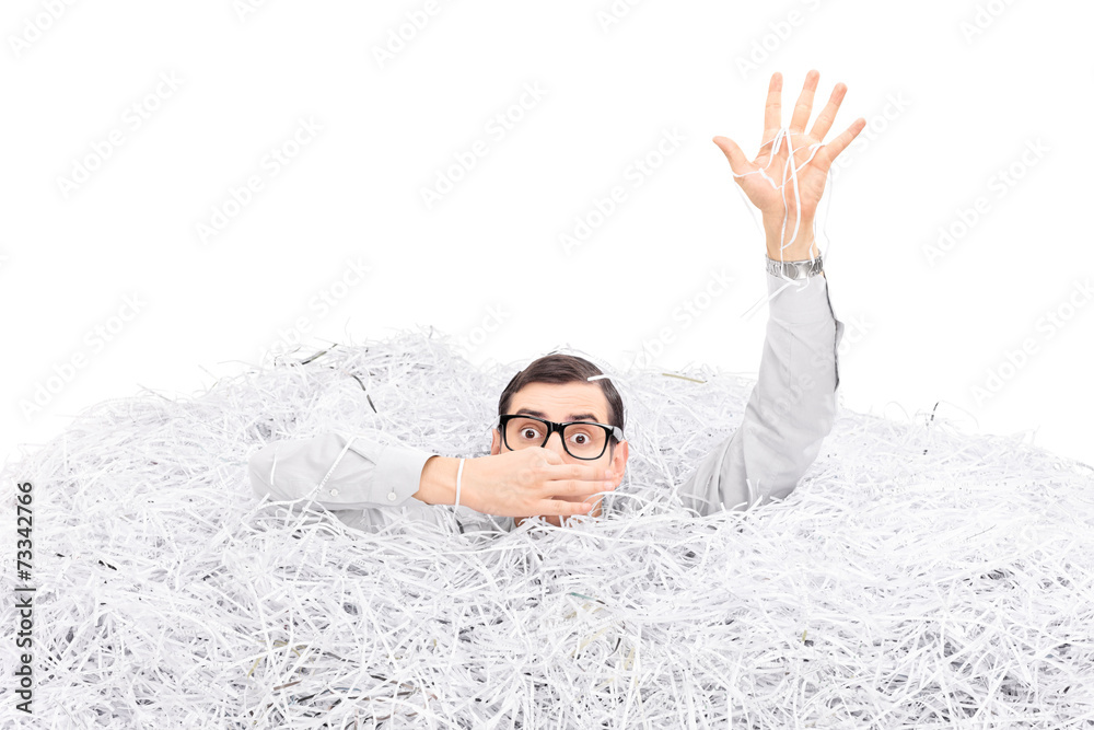 Man drowning in a pile of shredded paper Stock Photo | Adobe Stock
