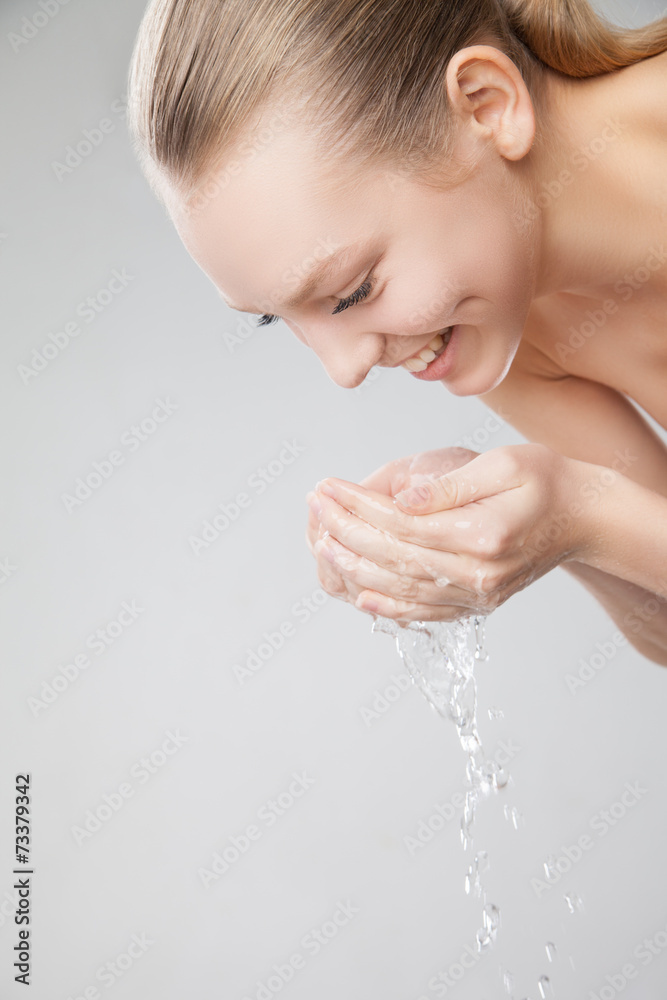 Beautiful woman washing her clean face with water Stock Photo | Adobe Stock