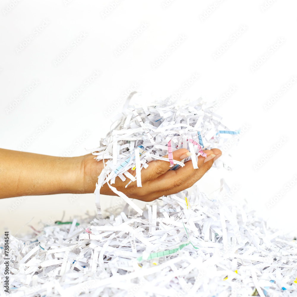 Hand holding Scrap Paper from paper cutter Stock Photo | Adobe Stock