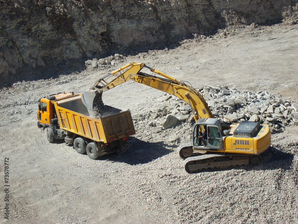 Loading of crushed stone in the truck excavator Stock Photo | Adobe Stock