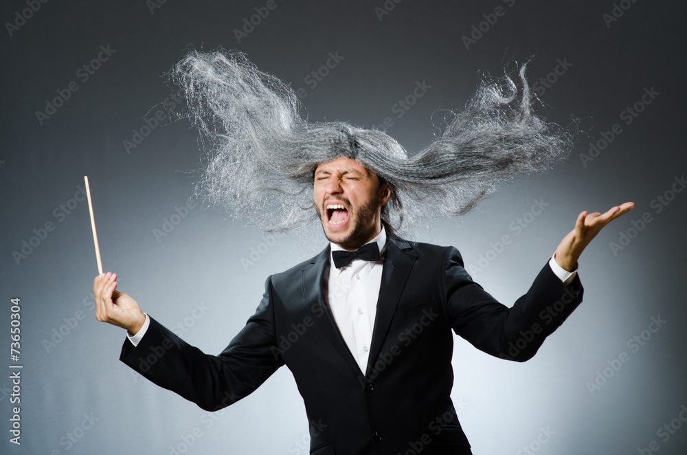 Funny conductor with long grey hair Stock Photo | Adobe Stock