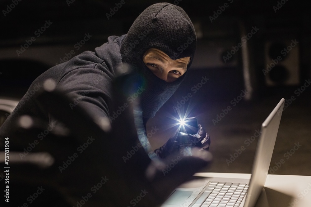 Robber looking at camera while making light with his phone Stock Photo ...