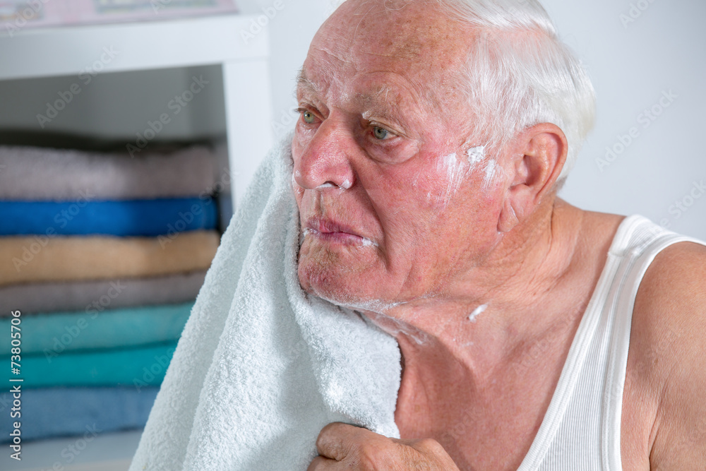 Senior man drying his face with towel after shaving. Stock-Foto | Adobe ...
