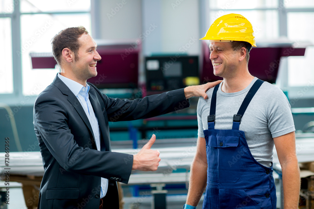 young boss and worker in factory Stock-Foto | Adobe Stock