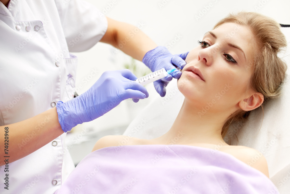 Beautiful woman gets an injection in her face Stock Photo | Adobe Stock