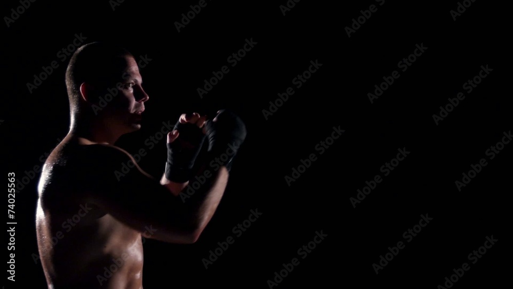 Boxer training shadow boxing over black background. Slow motion. Stock ...