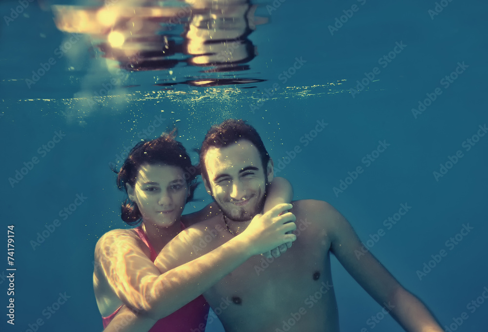 Boy and girl swimming underwater in pool. Stock Photo | Adobe Stock