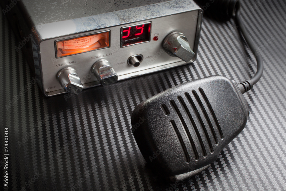 Two way radio and microphone on a carbon fiber surface ready to ...
