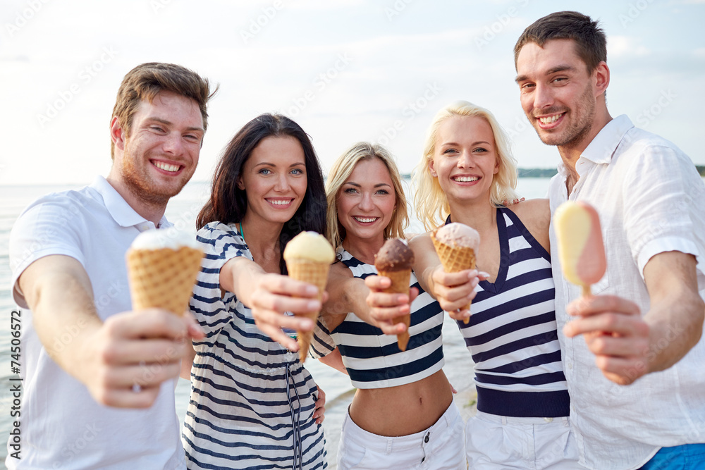 smiling friends eating ice cream on beach Stock Photo | Adobe Stock